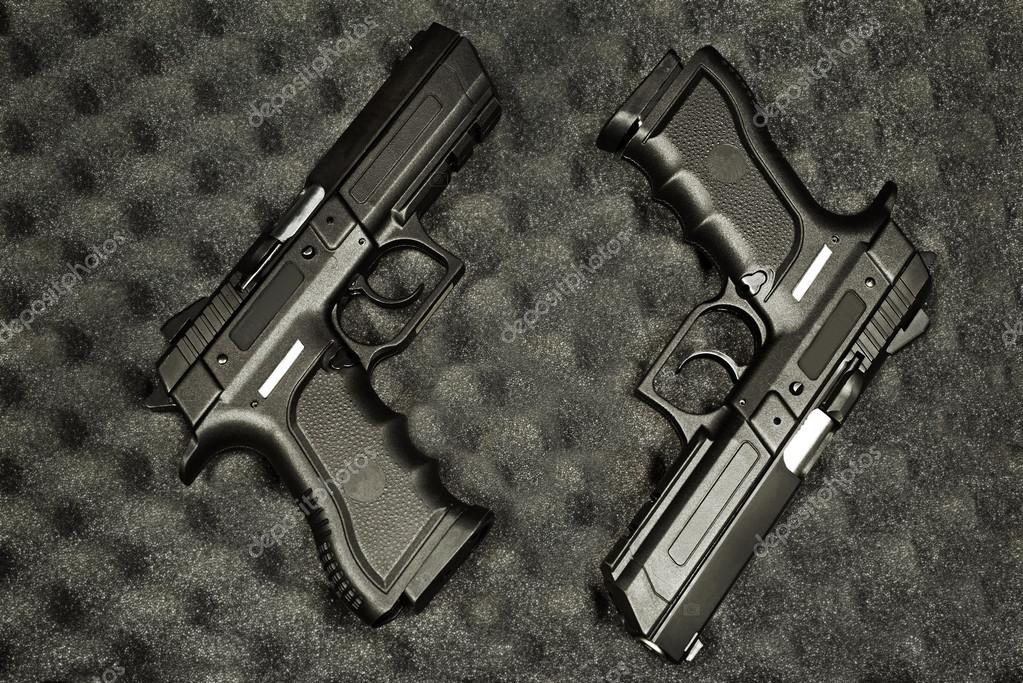 Two handguns on the black surface Stock Photo by ©RomanGloba 98735162