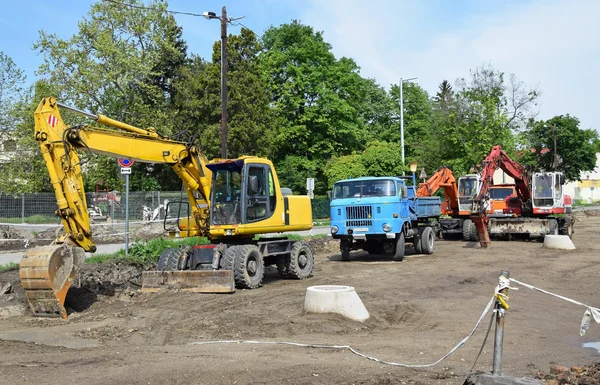 Excavator is working at the road construction — Stock Photo ...