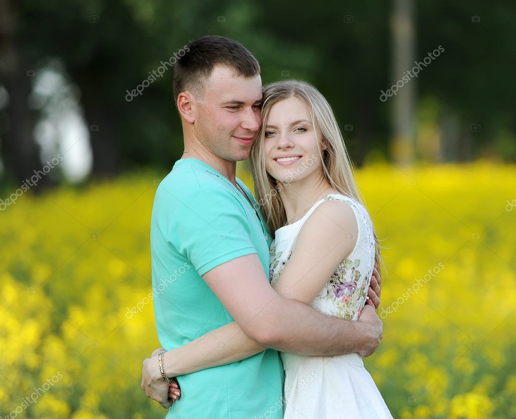 Pair on a solar rape field enjoy with each other — Stock Photo © avk78 ...
