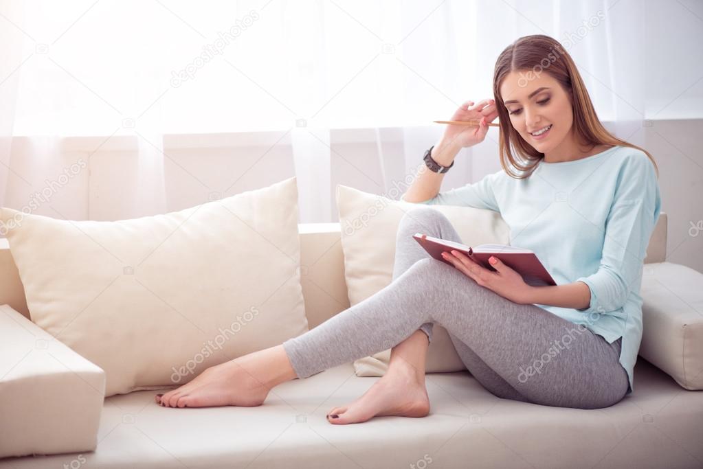 Delighted woman resting on the couch Stock Photo by ©yacobchuk1 109726832