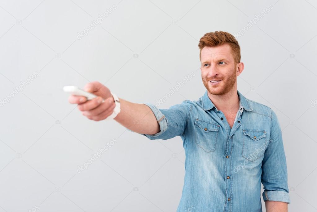 Positive man holding remote control ⬇ Stock Photo, Image by ...