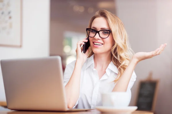 Nice young woman using laptop and phone - Stock Image - Everypixel
