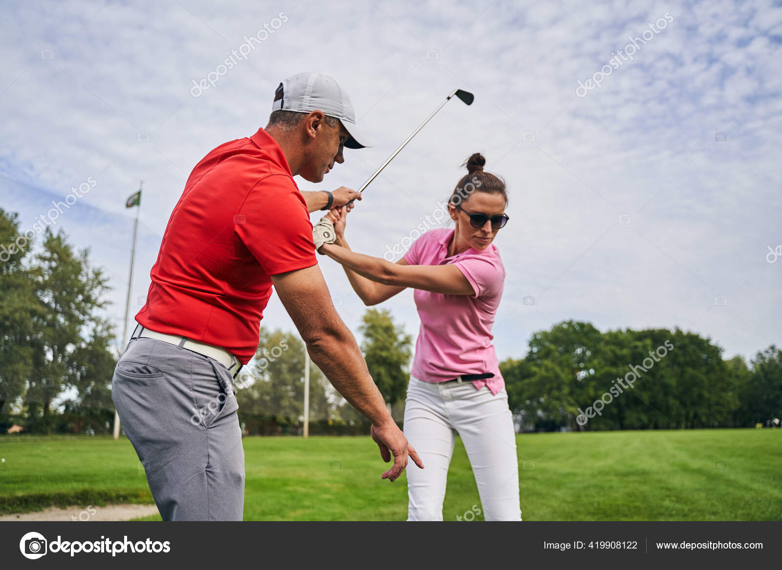 Golfer mastering a swing technique assisted by her coach — Stock Photo ...