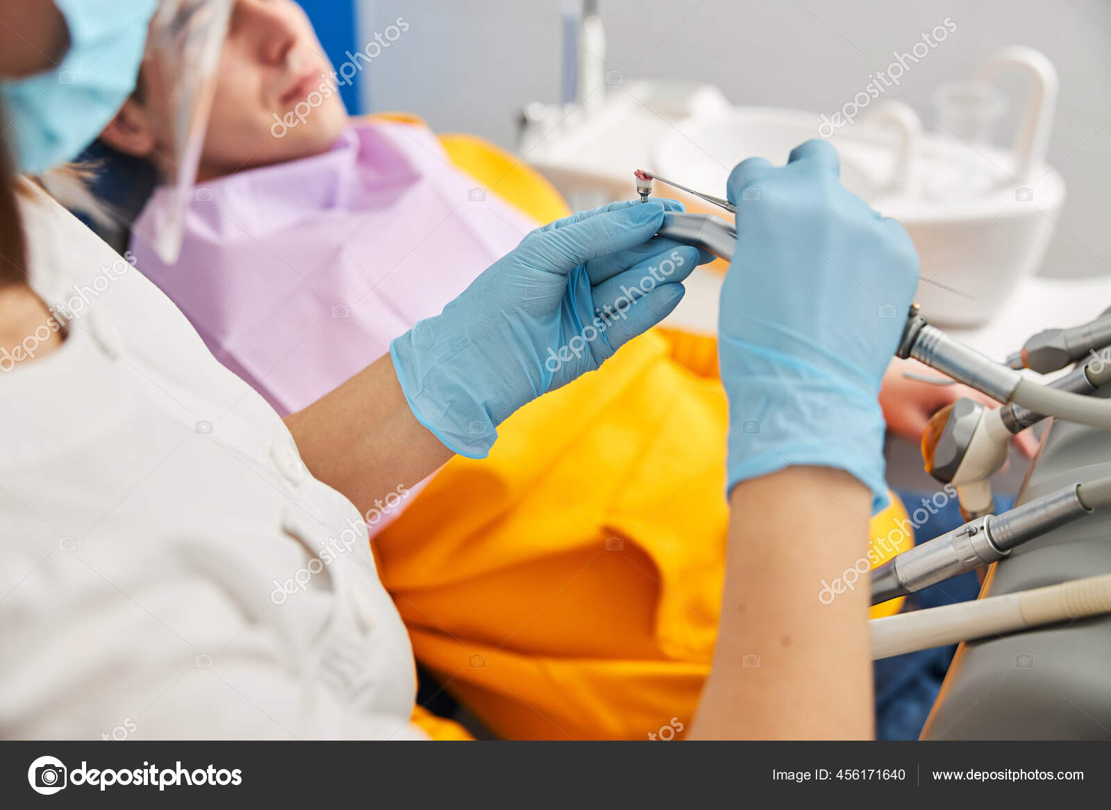 Medic carefully spreading prophy paste on polishing brush — Stock Photo ...