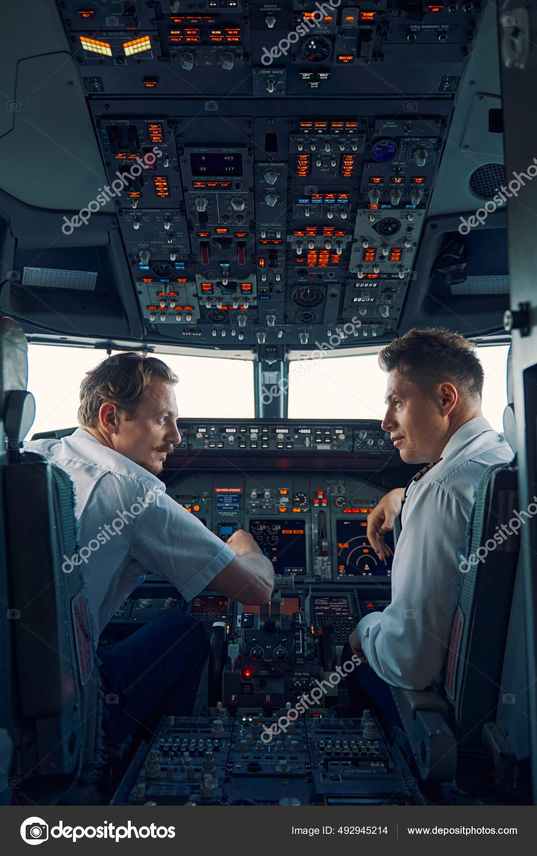 Two airmen dressed in uniforms sitting in the cockpit Stock Photo by ...