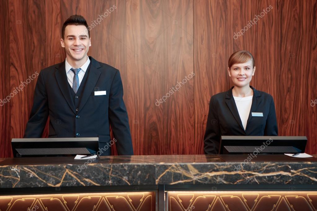 Hotel receptionists behind the counter Stock Photo by ©yacobchuk1 68169737