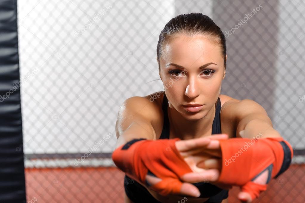 Female kickboxer poses at a ring — Stock Photo © yacobchuk1 #70080041