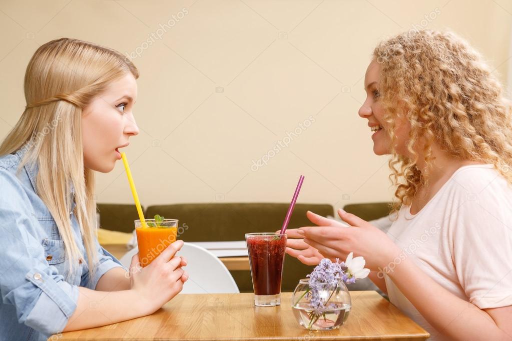 Two girls having conversation in cafe — Stock Photo © yacobchuk1 #73996007