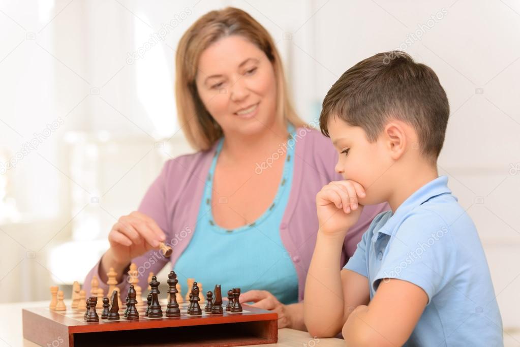 Grandma sitting at the table with boy Stock Photo by ©yacobchuk1 84729654