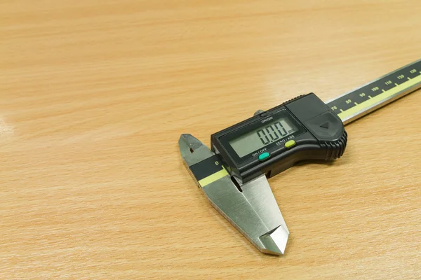 Vernier caliper on wooden table background - Stock Image - Everypixel