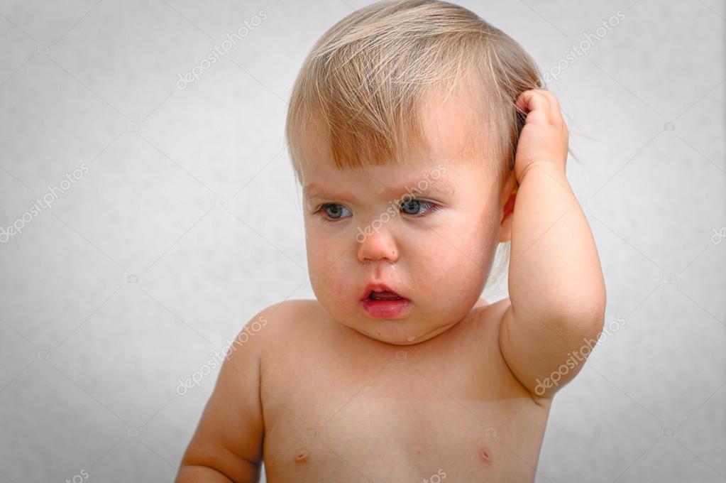 Tear-stained baby looking away scratching head — Stock Photo © Aynur ...