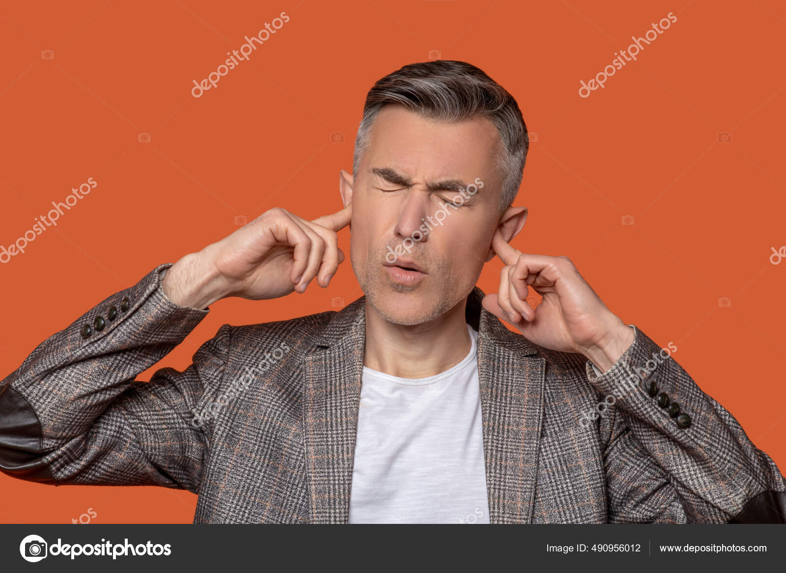 Man with drooping eyelids covering ears with fingers — Stock Photo ...