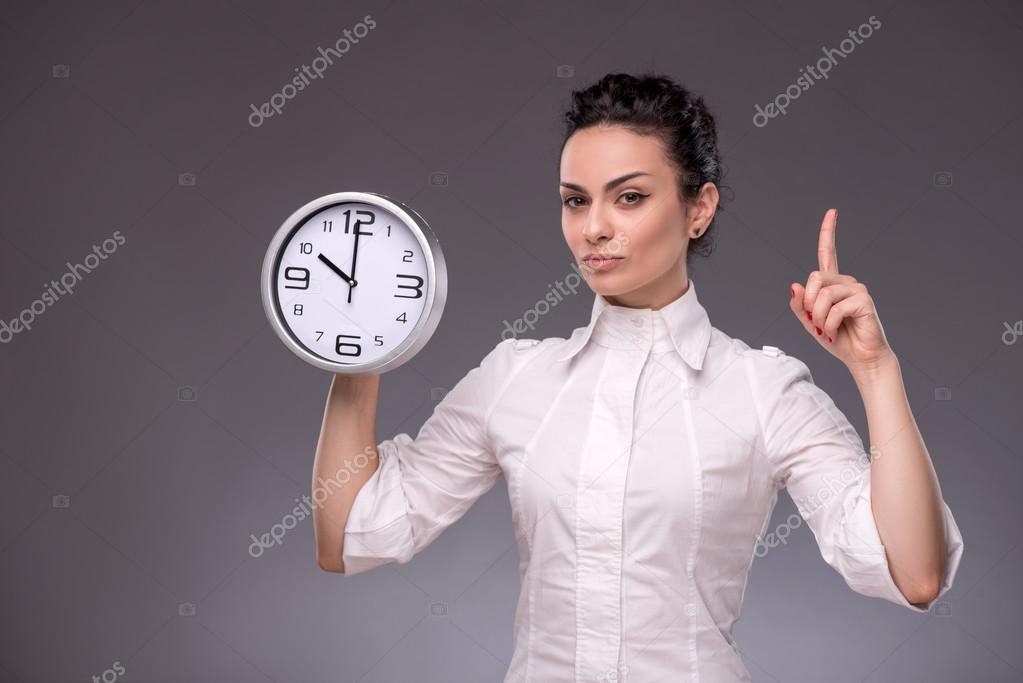 Girl holding clock and showing sign Attention — Stock Photo © Dmyrto_Z ...