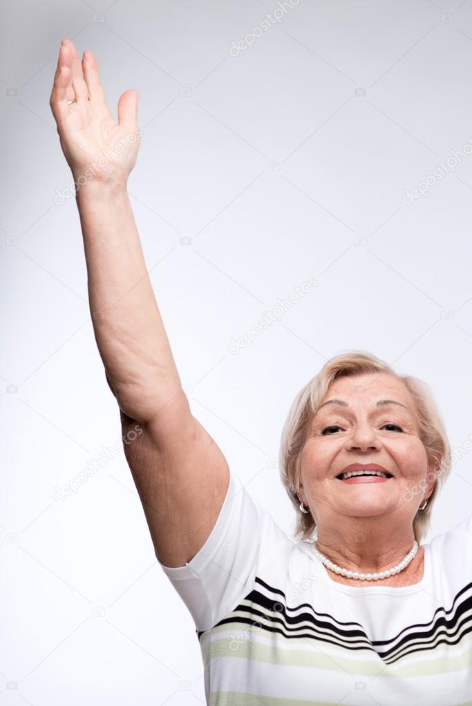 Elderly lady raising hands Stock Photo by ©Dmyrto_Z 62108727