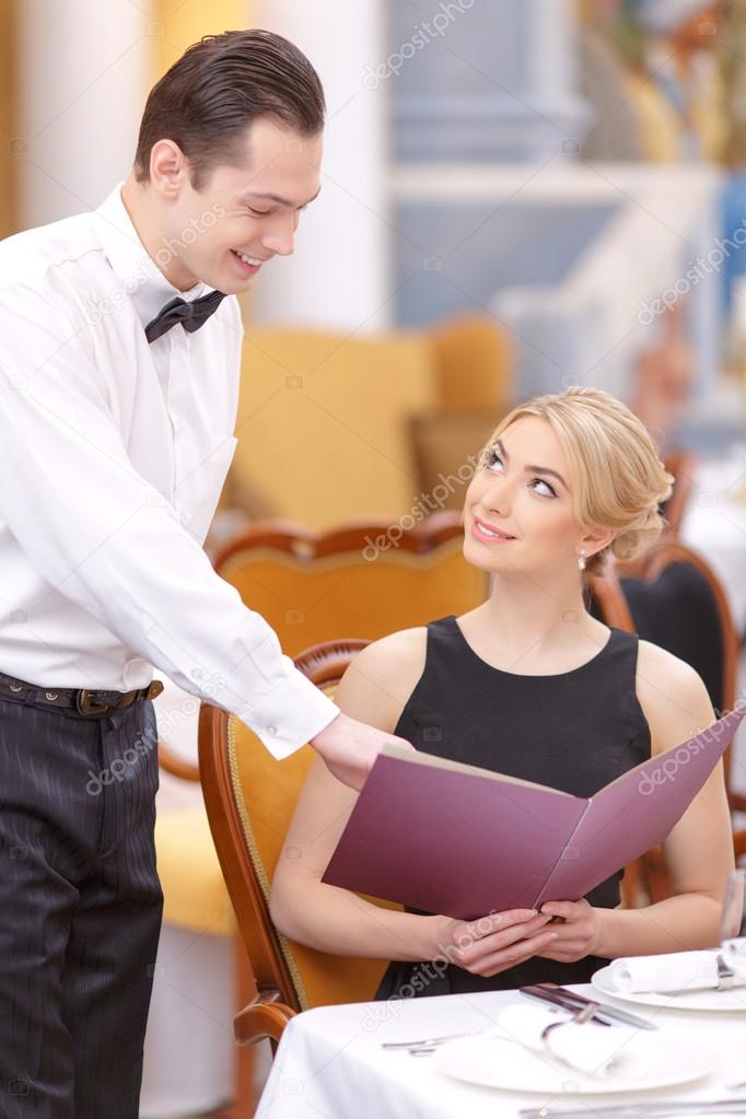 Woman looking waiter pointing at menu — Stock Photo © Dmyrto_Z #66960061