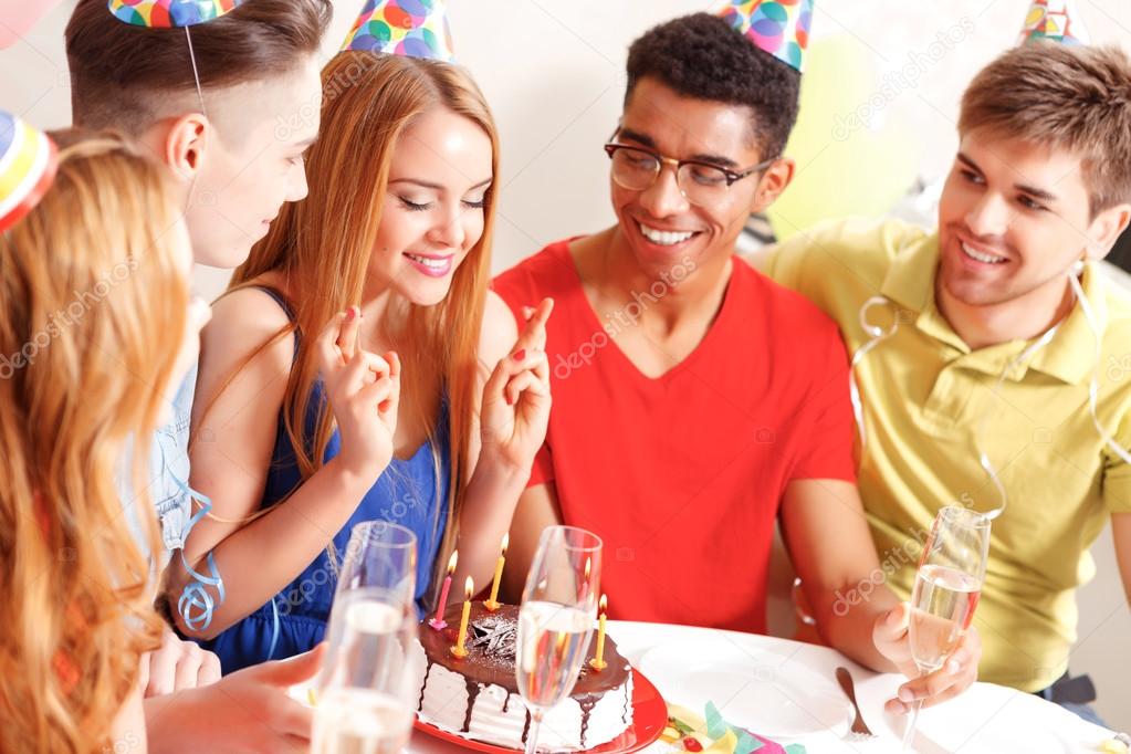 Young people celebrating a birthday sitting at the table Stock Photo by ...