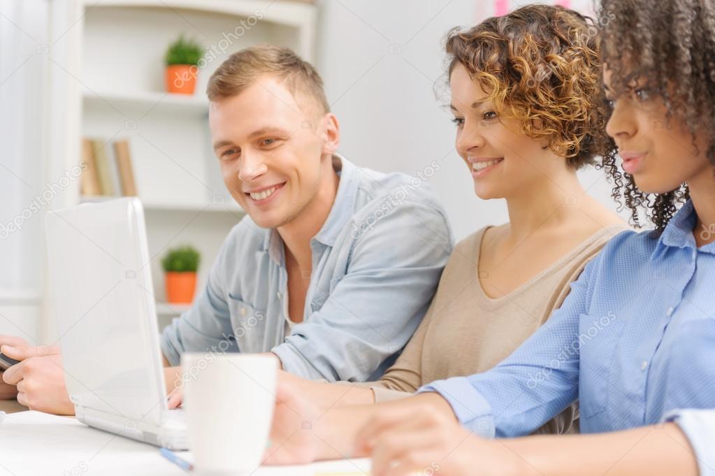 Three young people are collaborating in the office. Stock Photo by ...