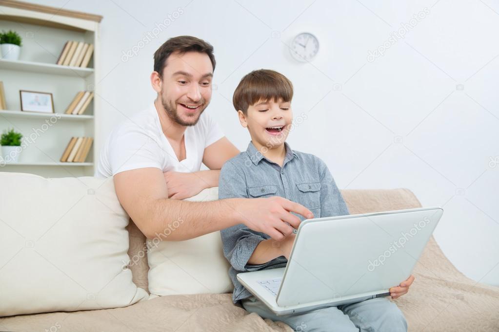 Father having hilarious time with son — Stock Photo © Dmyrto_Z #98487990