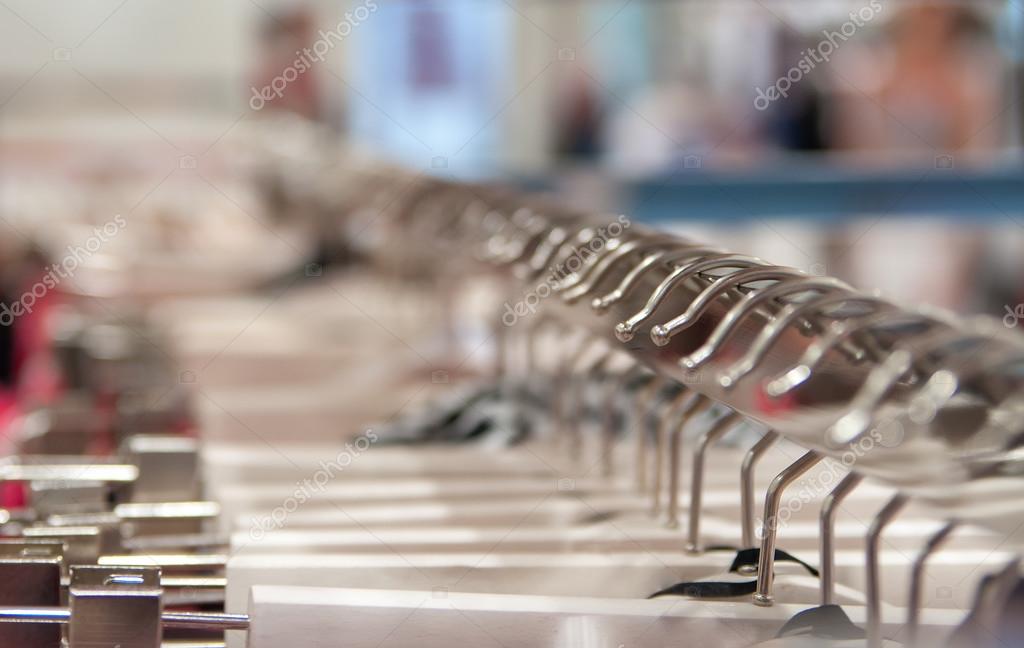 Clothes hang on a shelf in a clothes store Stock Photo by ©jutar 73299967