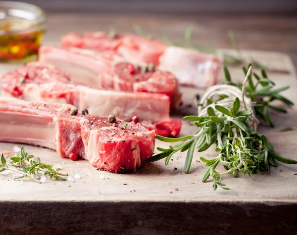 Raw meat, mutton, lamb rack on a wooden background - Stock Image ...