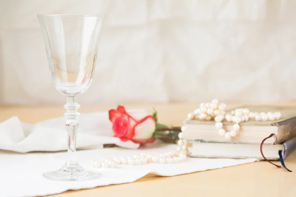 Beautiful empty glass with vintage books and pearls Stock Photo by ...