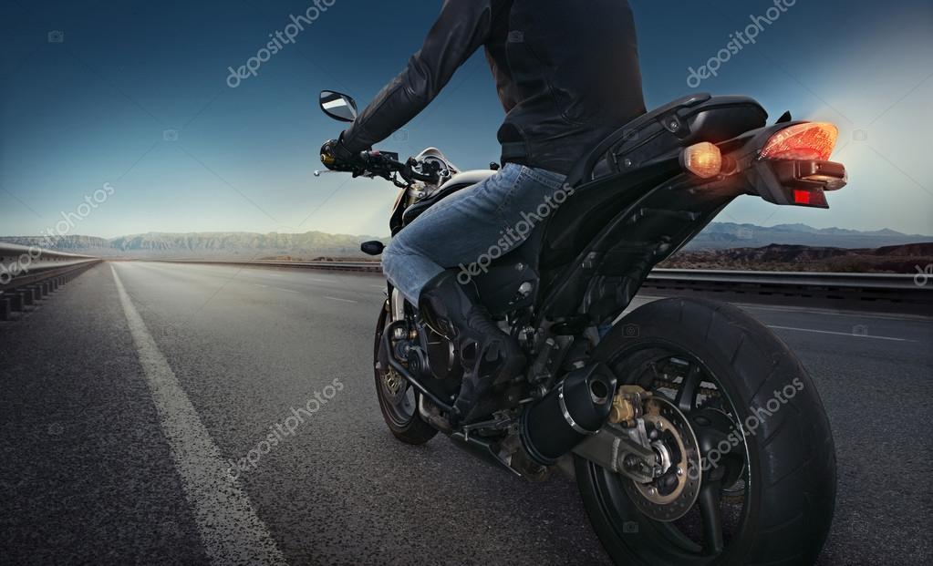 Biker riding motorcycle Stock Photo by ©Vitaliy_Melnik 52375121