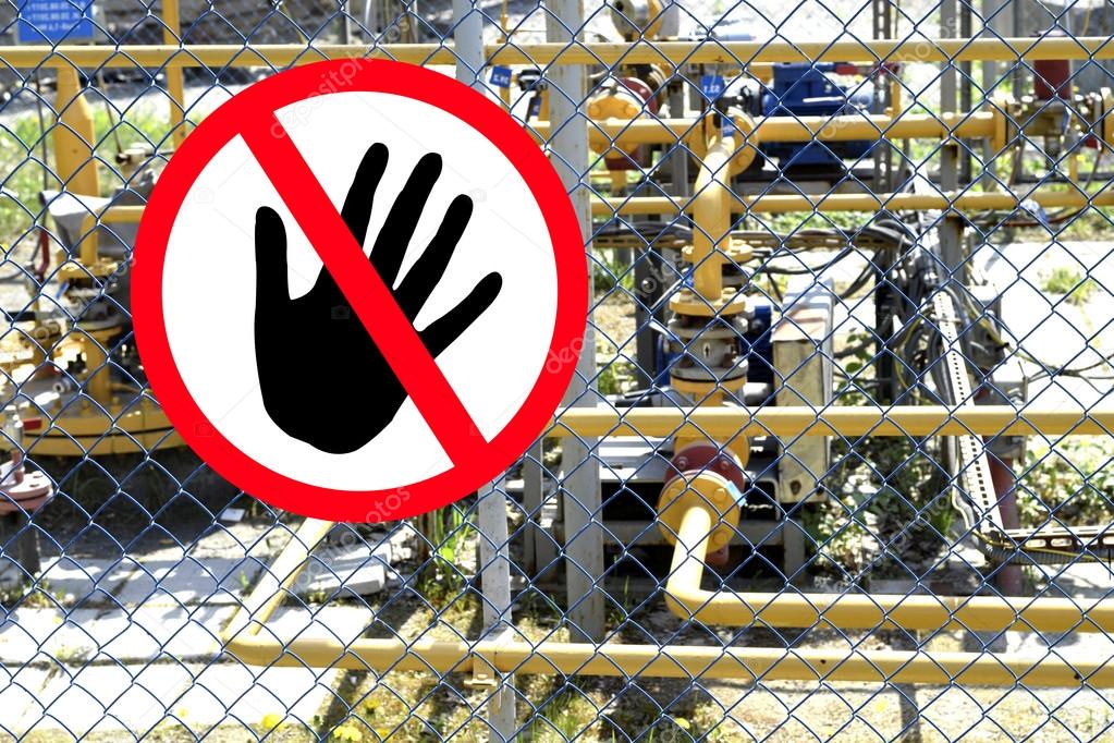 The sign " do not touch !" on the fence of an industrial facility ...