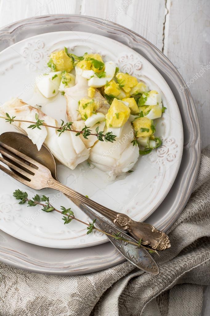 Boiled white fish cod with a sauce based on butter and boiled eggs ...