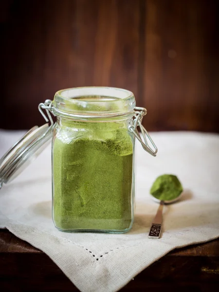 Moringa powder in a glass jar. - Stock Image - Everypixel