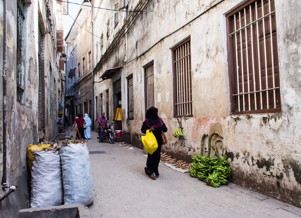 Local people walking on one of the narrow streets - Stock Image ...
