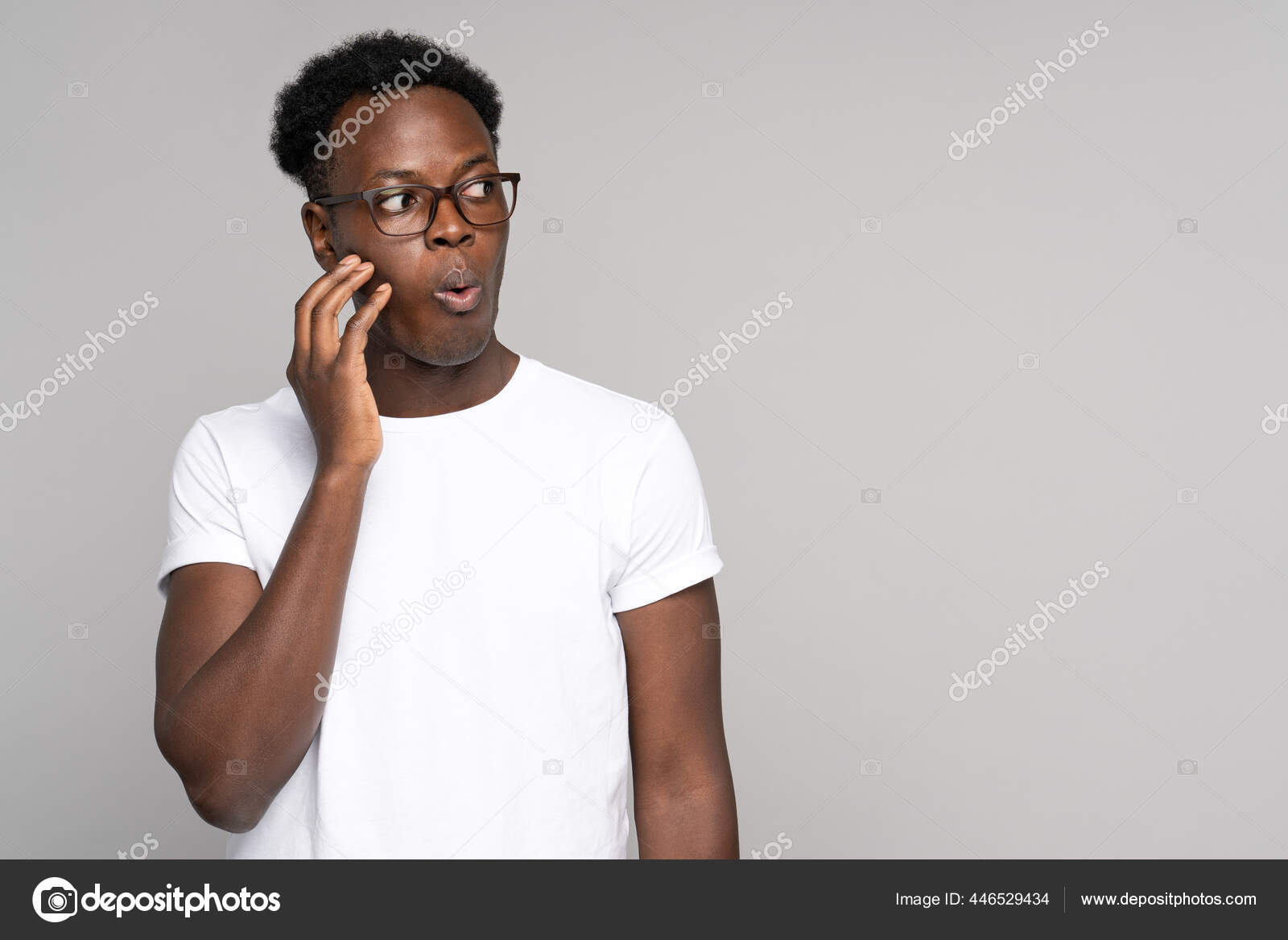 Surprised afro man makes big eyes opens, touching her face, shocked ...