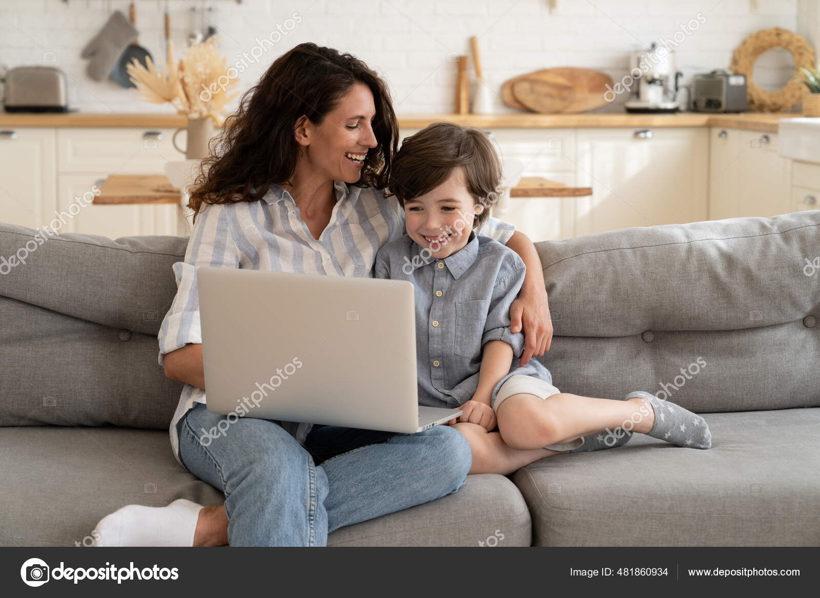 Young single mother relax after work with cute preschool son watching ...