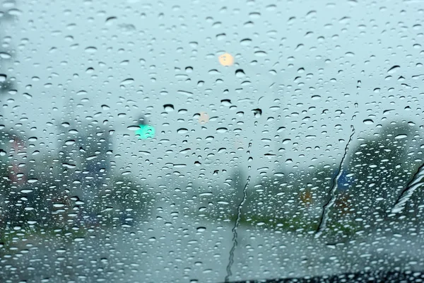 Road view through car window with rain drops - Stock Image - Everypixel