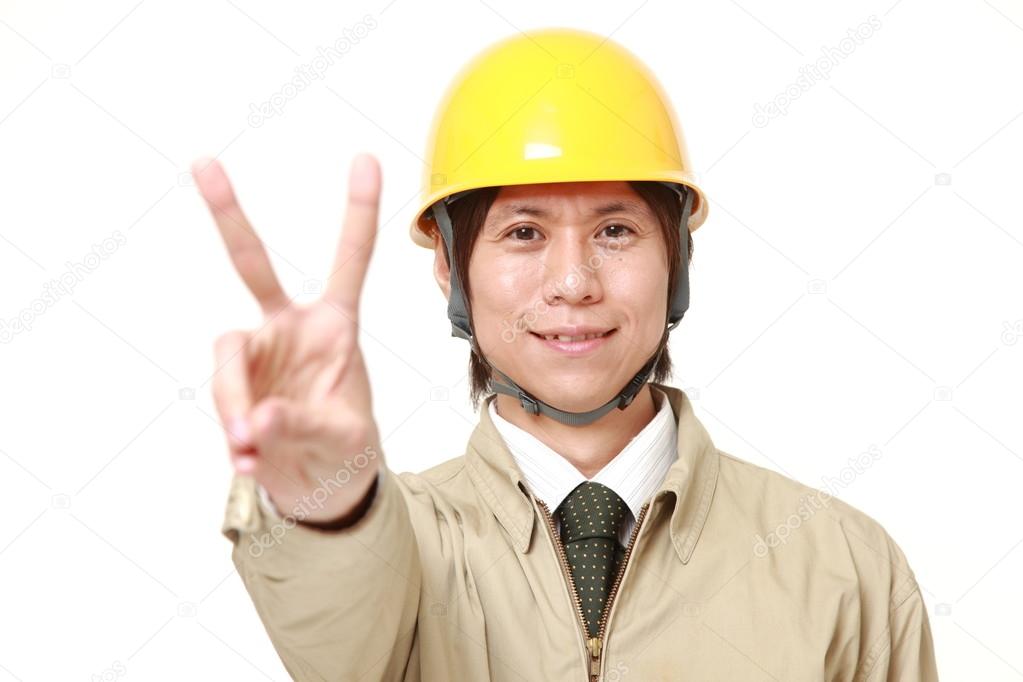 Young Japanese construction worker showing a victory sign Stock Photo ...
