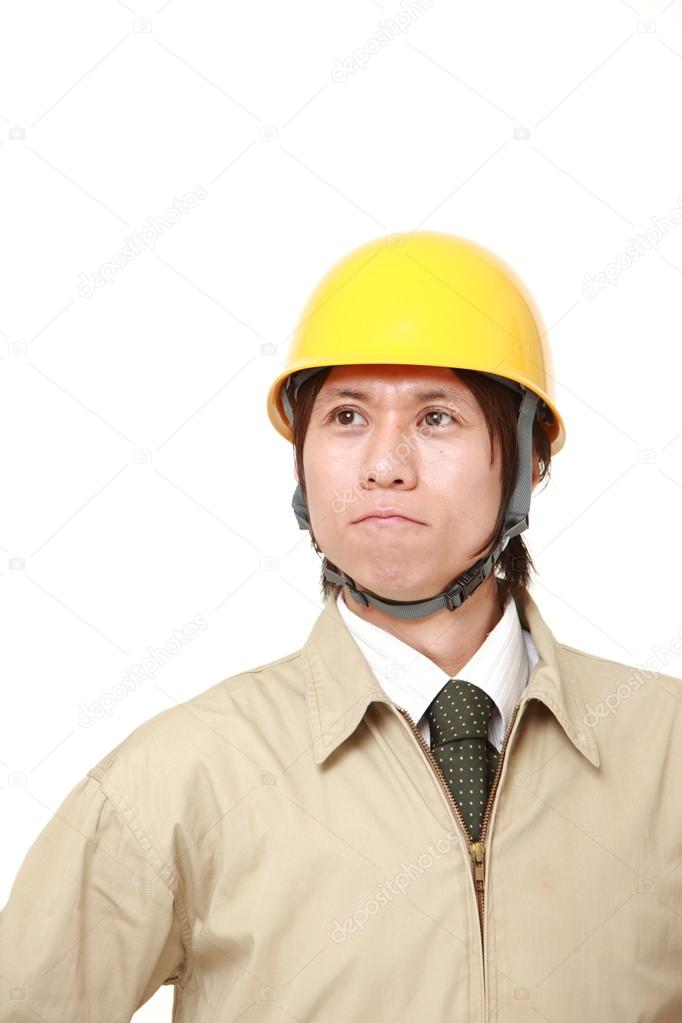 Young Japanese construction worker looking up — Stock Photo © deeblue ...