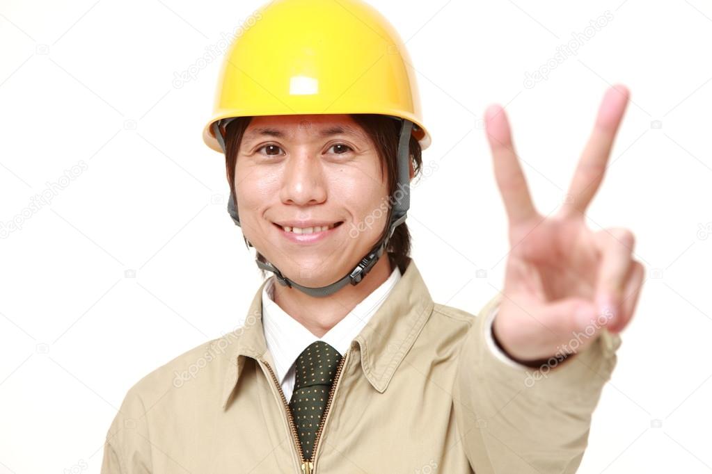 Young Japanese construction worker showing a victory sign — Stock Photo ...