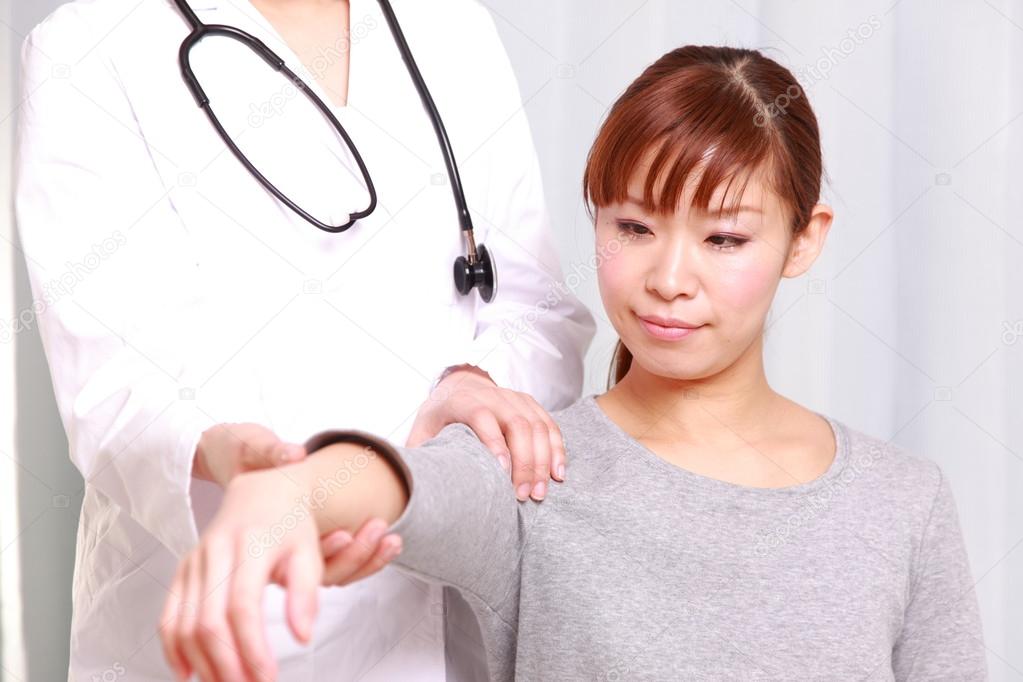 Young Japanese woman getting chiropractic — Stock Photo © deeblue #56900865