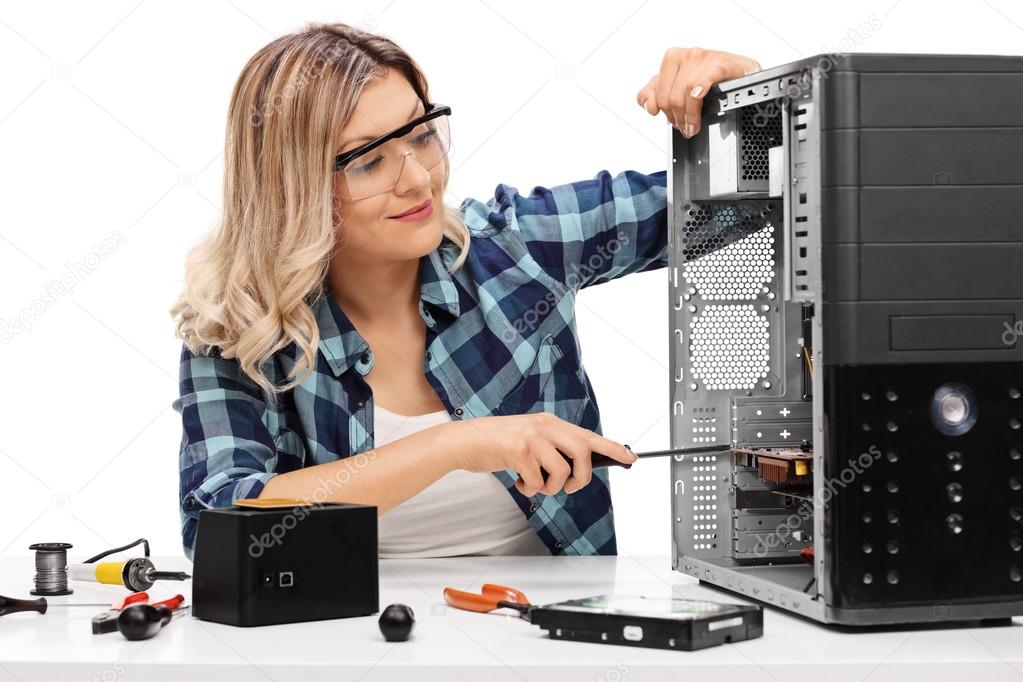 Young blond woman fixing a computer — Stock Photo © ljsphotography ...