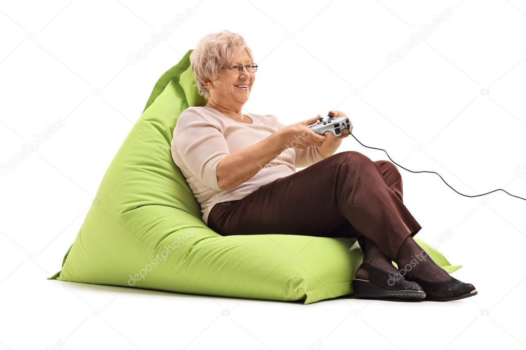 Elderly lady playing video games Stock Photo by ©ljsphotography 111094450