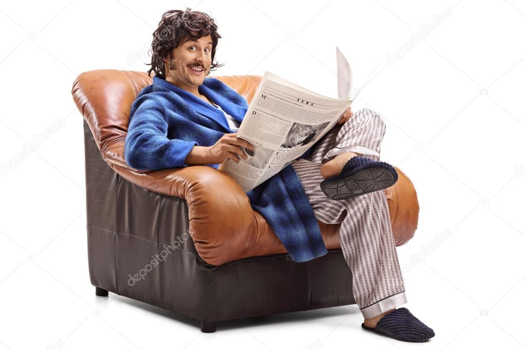 Man reading the newspaper seated in an armchair — Stock Photo ...