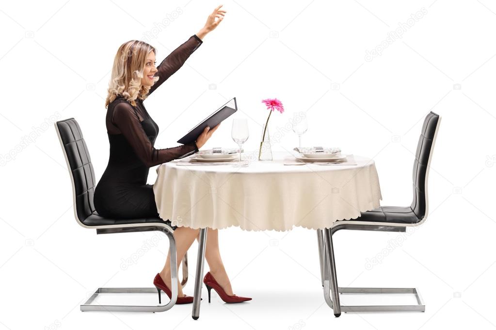 Woman calling a waiter in restaurant Stock Photo by ©ljsphotography ...