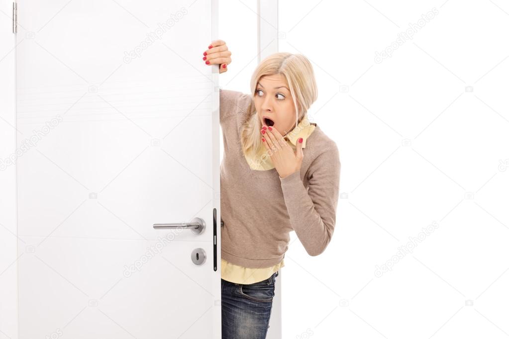 Mujer espiando desde detrás de una puerta: fotografía de stock ...