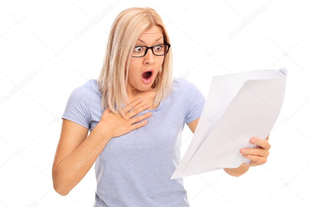 Baffled woman looking at a piece of paper — Stock Photo ...