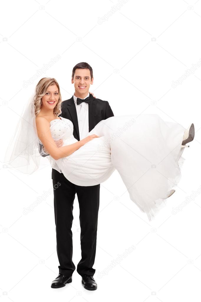 Groom carrying a bride in his hands Stock Photo by ©ljsphotography 96374536