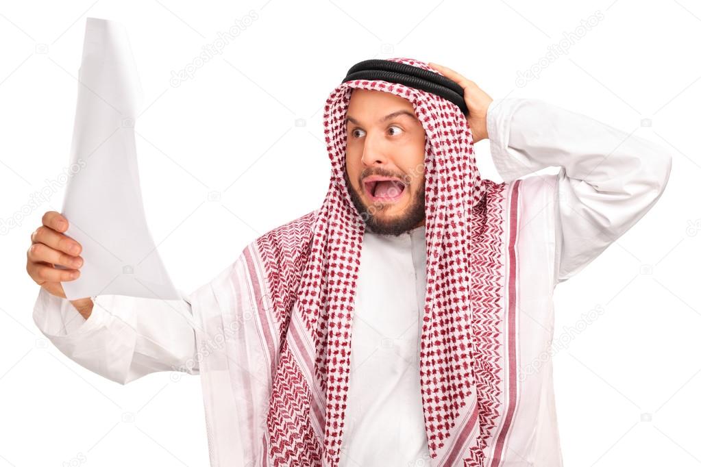 Shocked Arab looking at a piece of paper — Stock Photo © ljsphotography ...