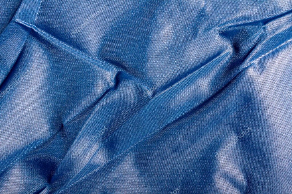 Textura telón de fondo foto de color azul y doblado tela de Bolonia. 2023