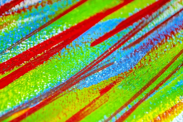 Many different multi-colored lines are chaotically drawn with brush ...