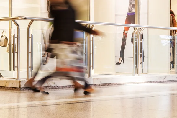 People in motion blur in a shopping mall — Stock Photo © Madrabothair ...