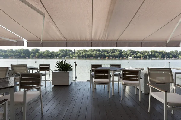 Modern riverside cafe terrace — Stock Photo © rilueda #64831683