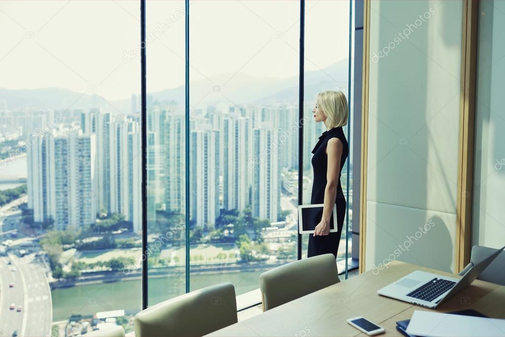Successful woman CEO looking in window — Stock Photo © GaudiLab #110891842 Successful woman CEO looking in window — Stock Photo © GaudiLab #110891842